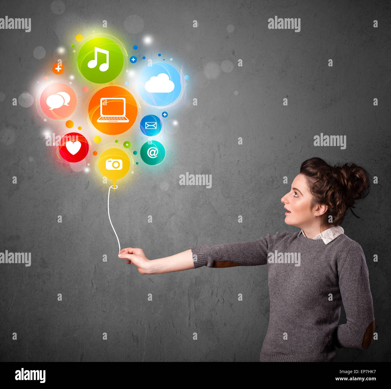 Woman holding social media balloon Stock Photo - Alamy