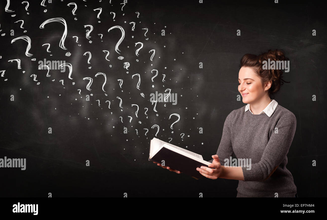 Pretty woman reading a book with question marks coming out from it ...