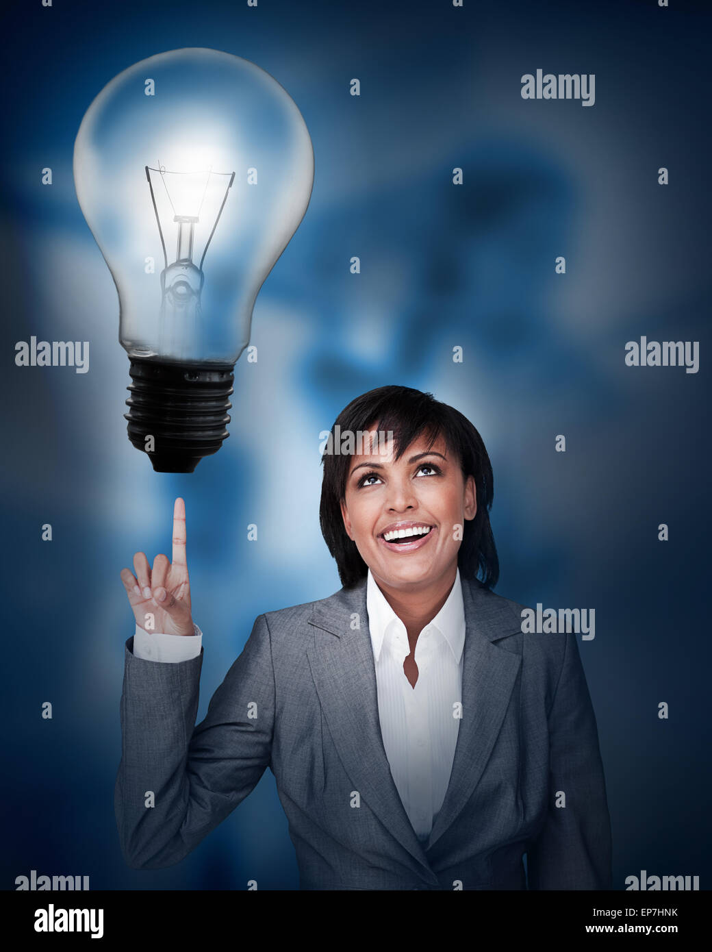 Businesswoman looking up at the big light bulb Stock Photo - Alamy
