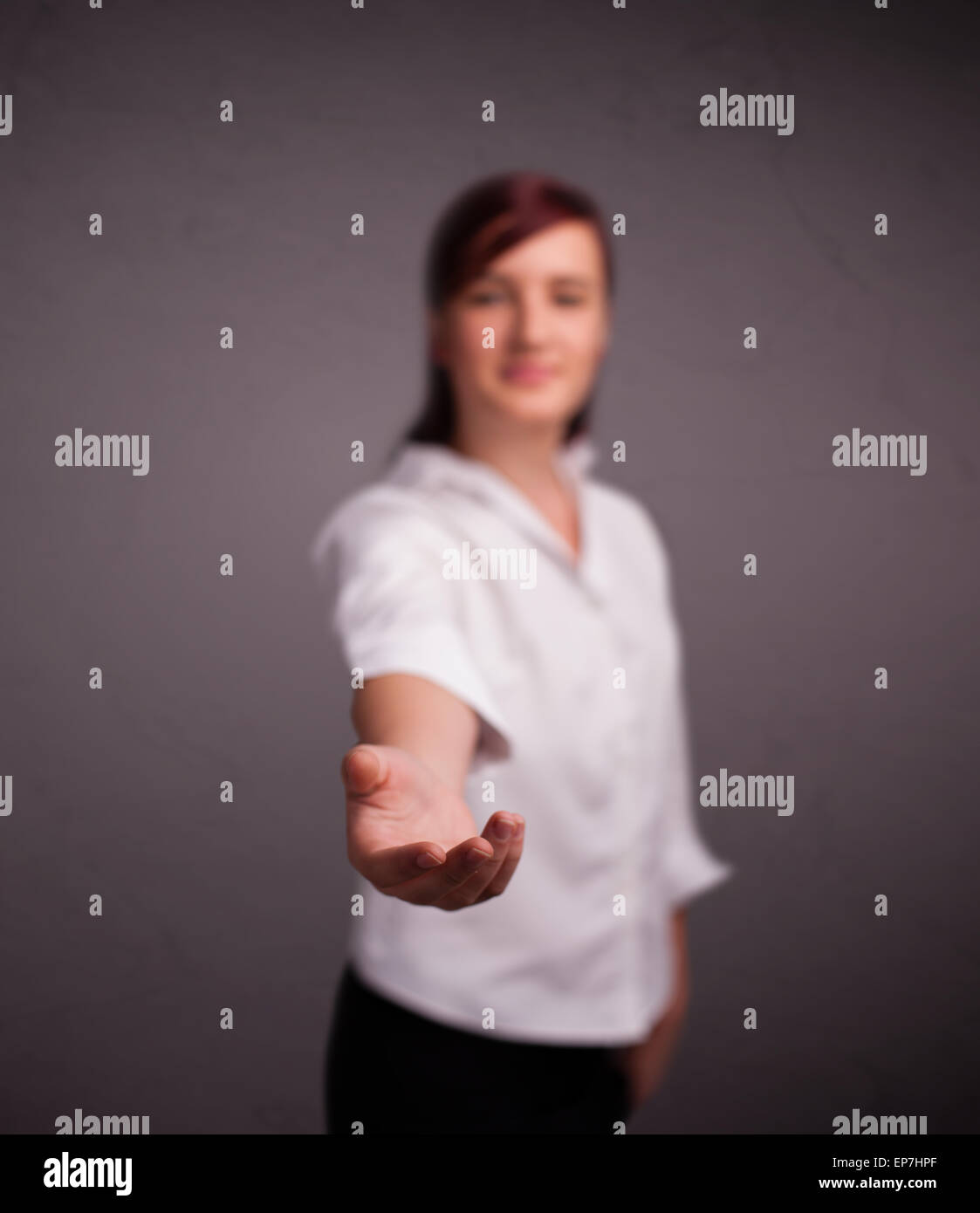 Pretty girl holding something Stock Photo - Alamy