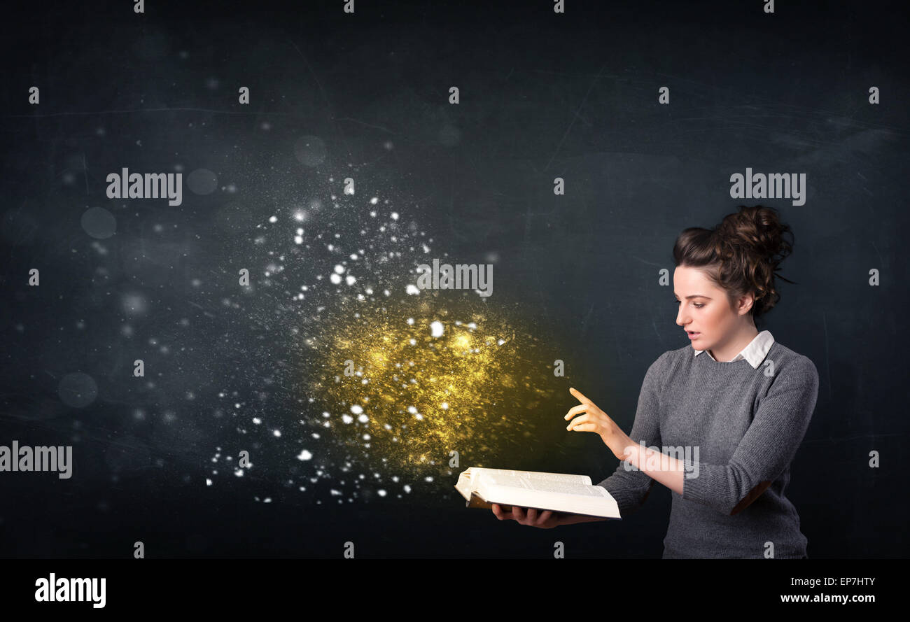 Young lady reading a magical book Stock Photo - Alamy