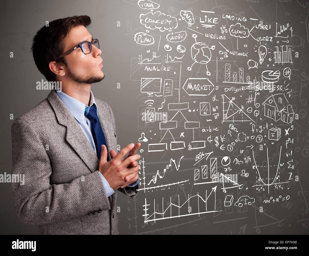 Attractive man looking at stock market graphs and symbols Stock Photo ...