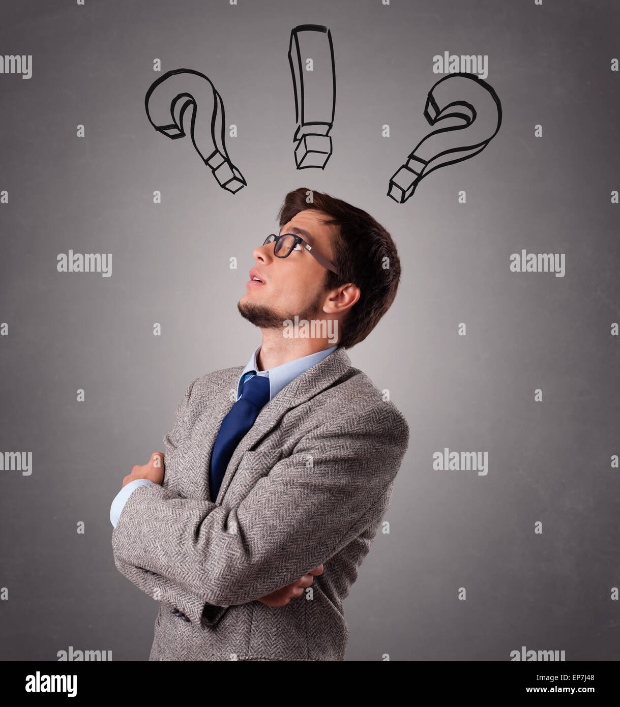 Young man thinking with question marks overhead Stock Photo - Alamy