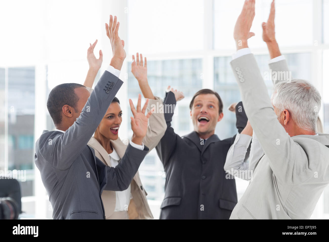 Group of smiling business people raising their hands Stock Photo - Alamy