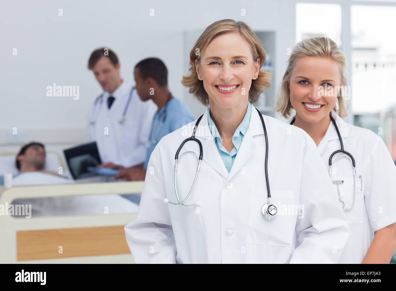 Two women doctors standing and looking at the camera Stock Photo - Alamy