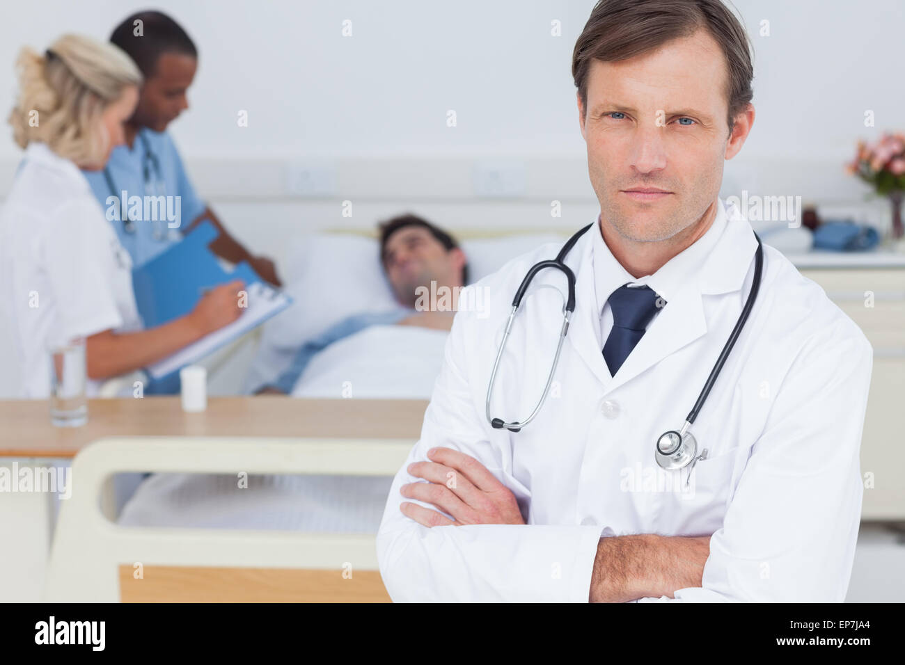 Serious doctor standing and looking at the camera Stock Photo - Alamy