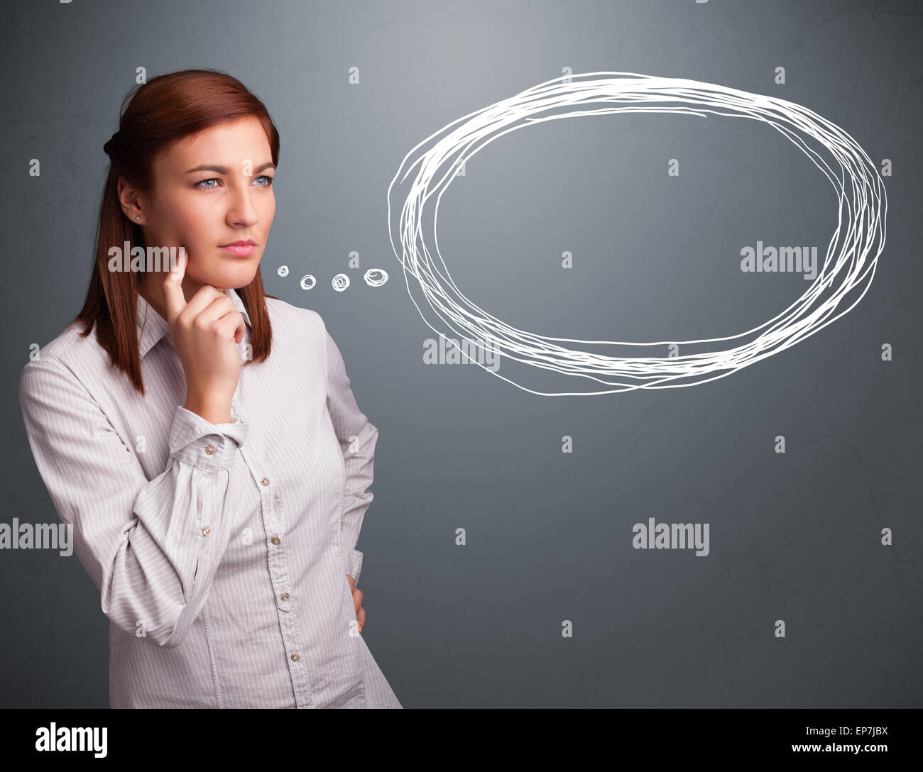 Young lady thinking about speech or thought bubble with copy space ...