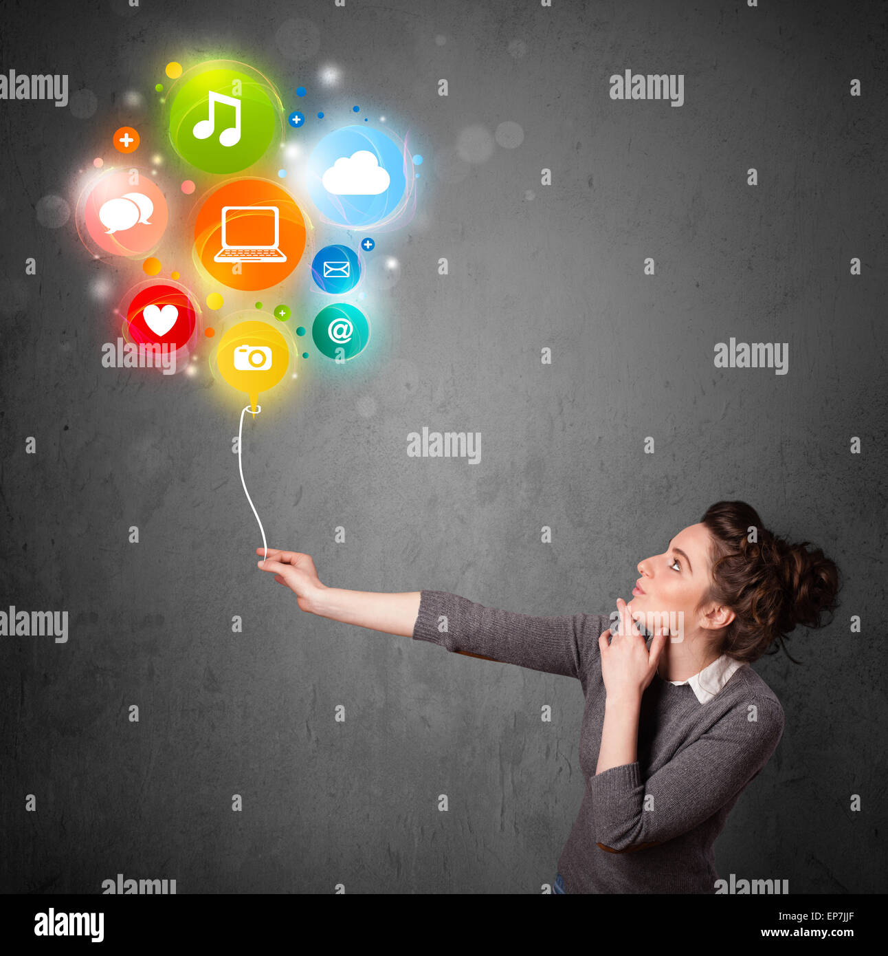 Woman holding social media balloon Stock Photo - Alamy