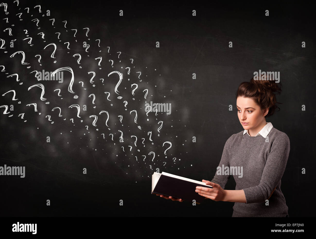 Pretty woman reading a book with question marks coming out from it ...