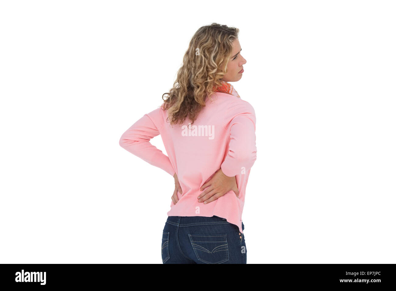 Woman having a back ache and holding her back Stock Photo - Alamy