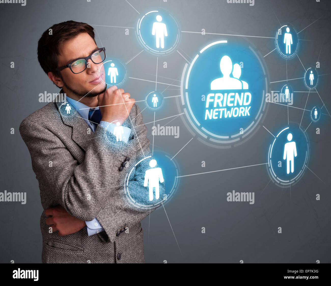 Handsome man looking at modern social network Stock Photo - Alamy