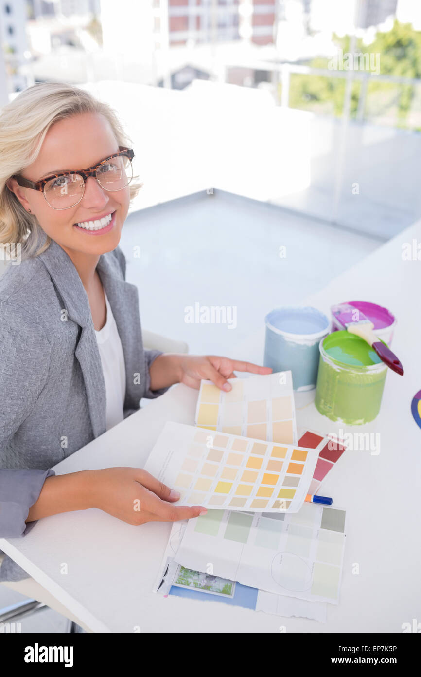 Blonde interior designer holding colour charts Stock Photo - Alamy