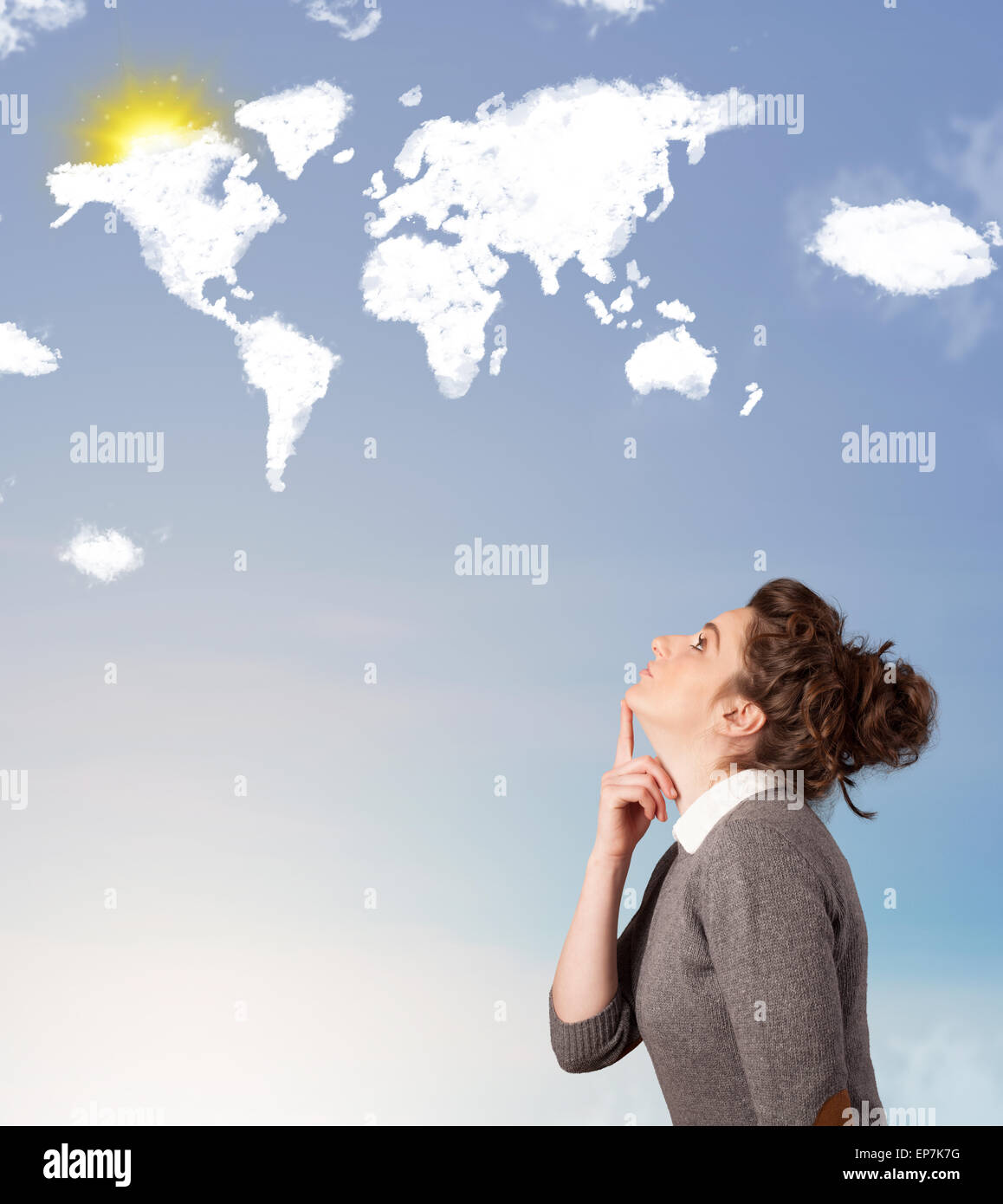 Young girl looking at world clouds and sun on blue sky Stock Photo - Alamy