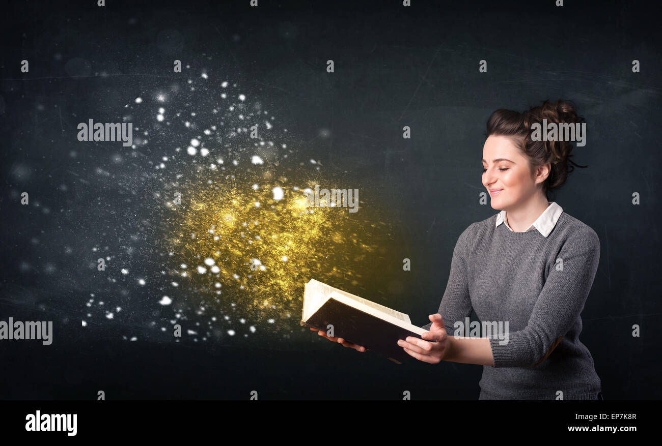 Young lady reading a magical book Stock Photo - Alamy