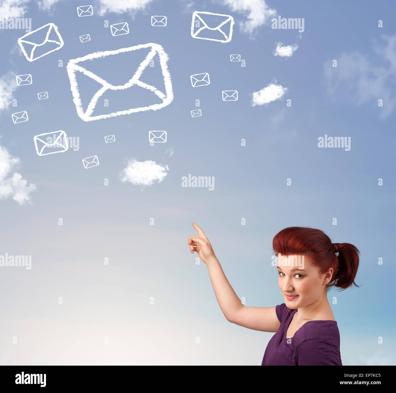 Young girl looking at mail symbol clouds on blue sky Stock Photo - Alamy