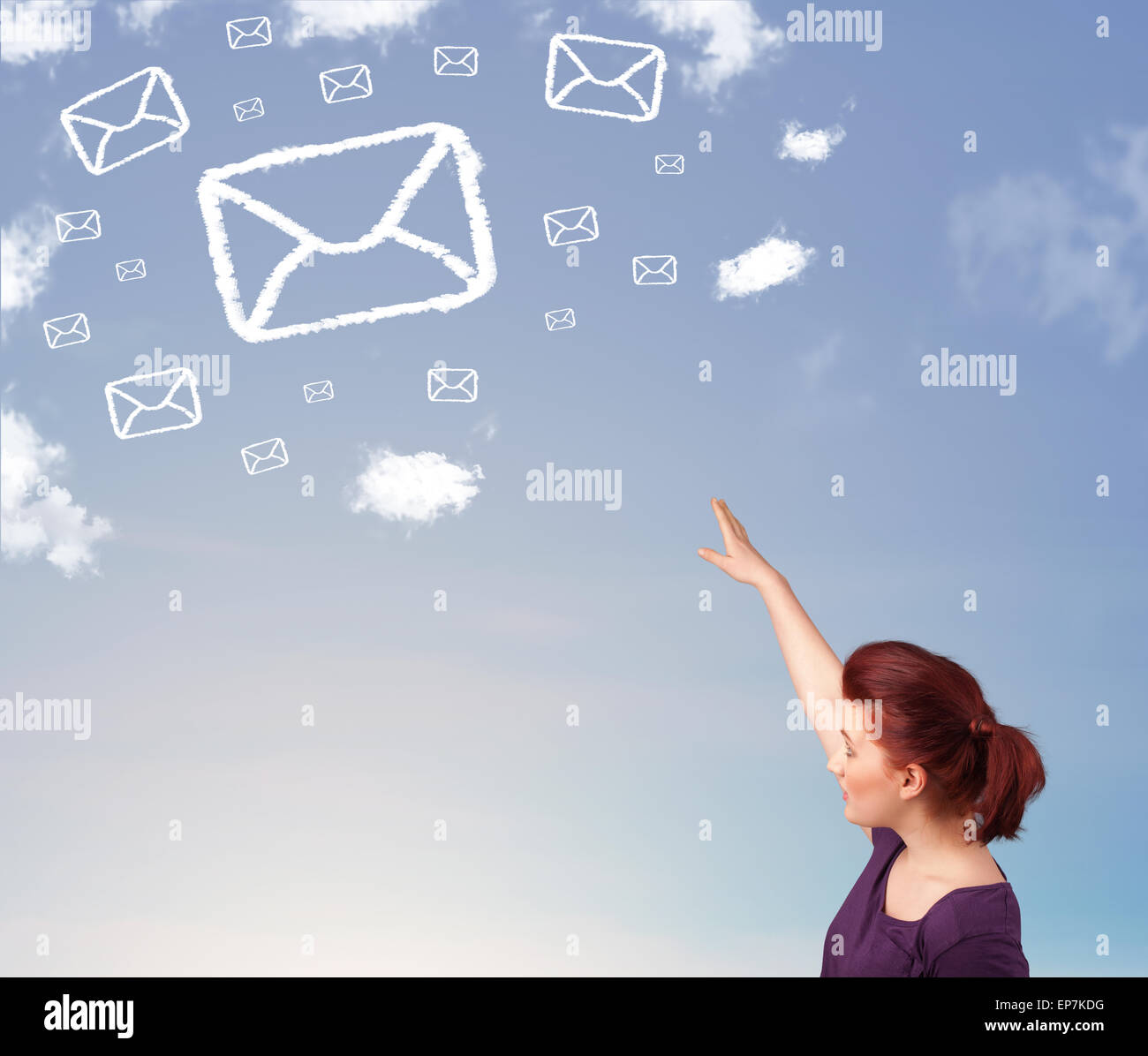 Young girl looking at mail symbol clouds on blue sky Stock Photo - Alamy