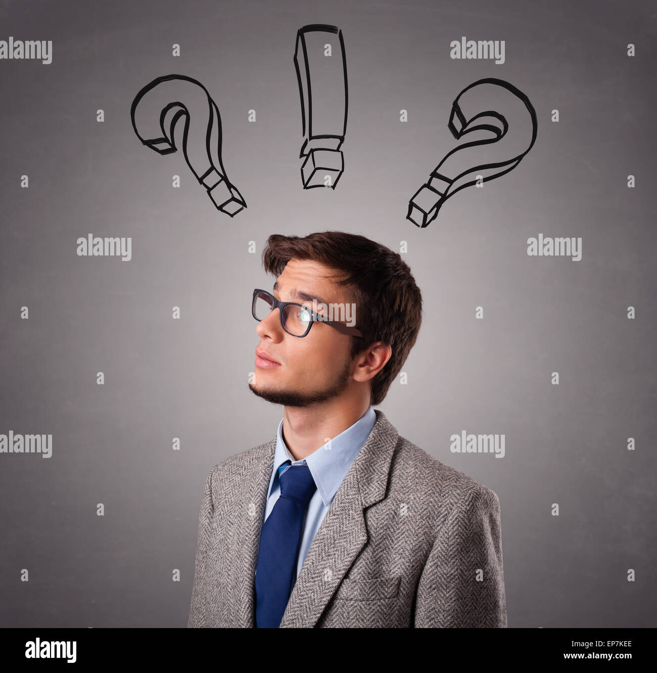 Young man thinking with question marks overhead Stock Photo - Alamy