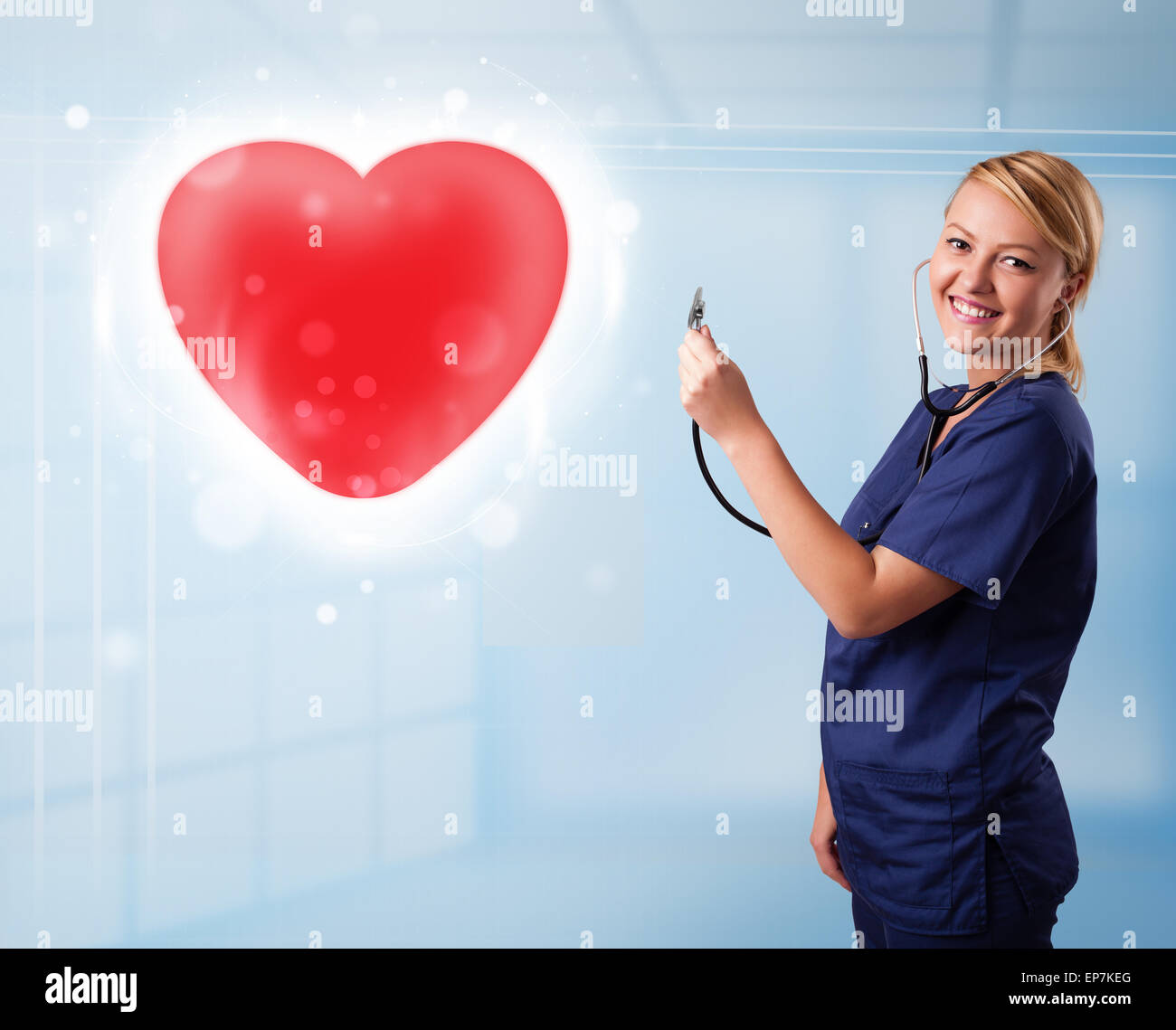 Young nurse healing a red heart Stock Photo - Alamy