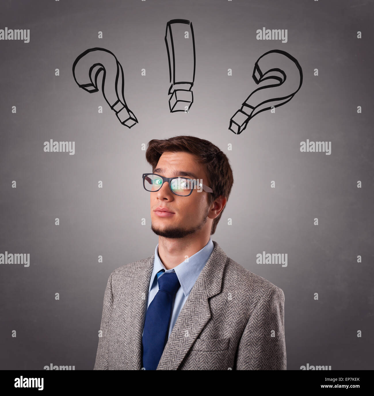 Young man thinking with question marks overhead Stock Photo - Alamy