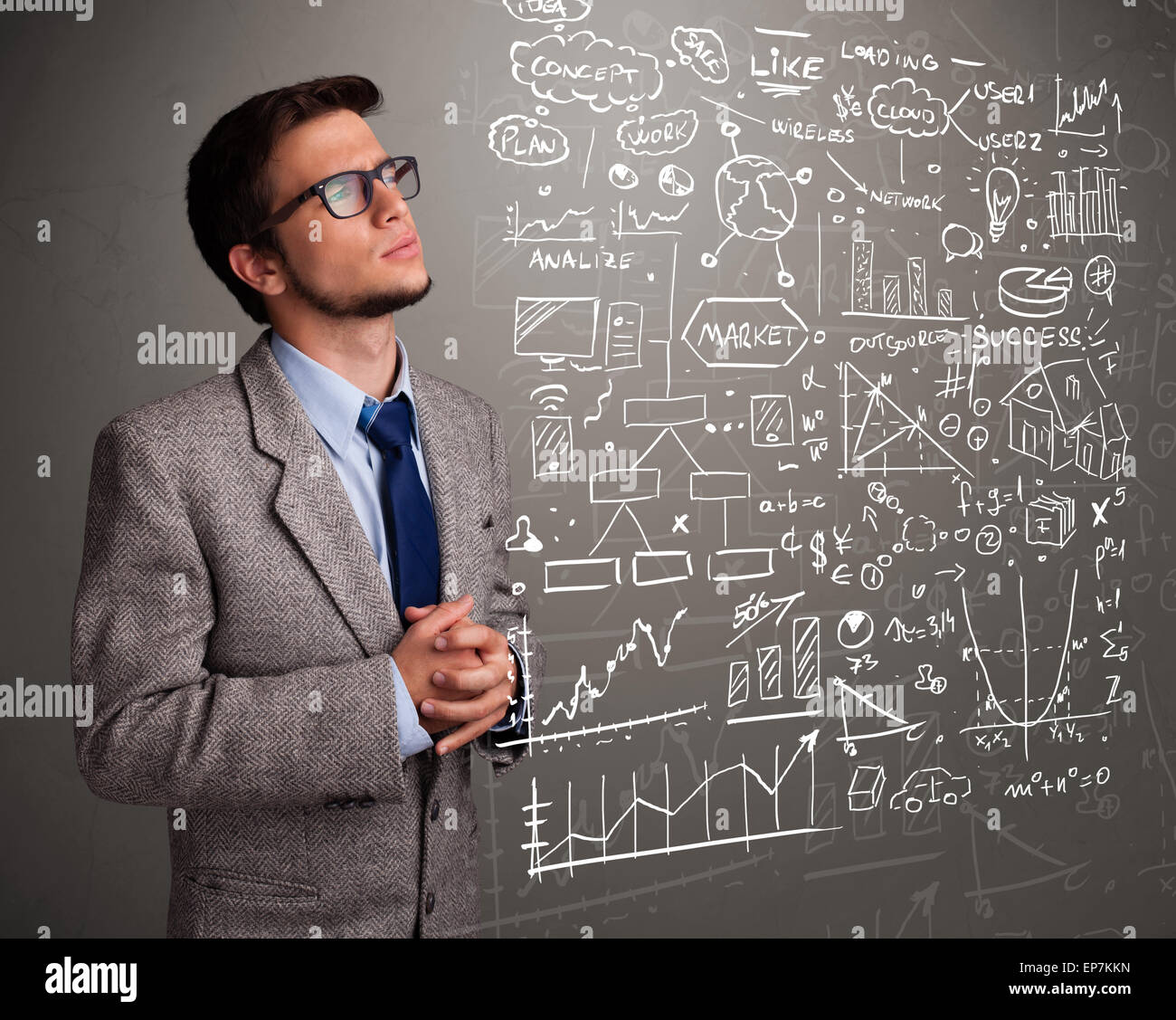 Attractive man looking at stock market graphs and symbols Stock Photo ...