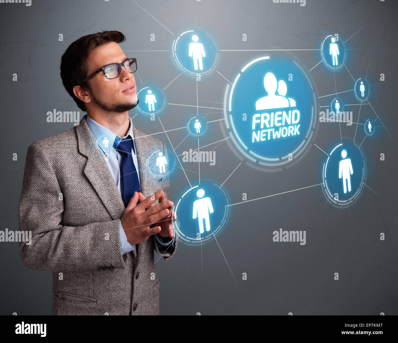 Handsome man looking at modern social network Stock Photo - Alamy
