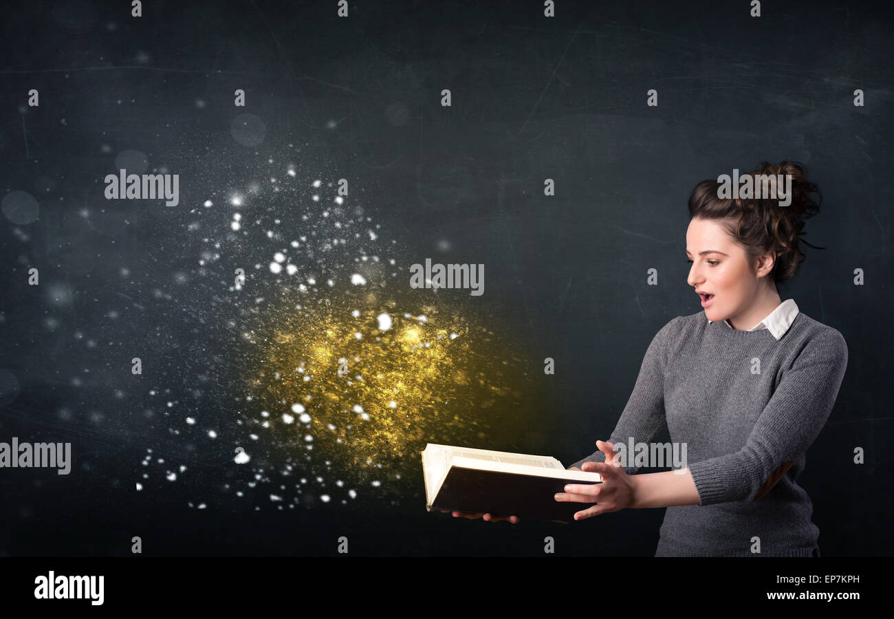 Young lady reading a magical book Stock Photo - Alamy
