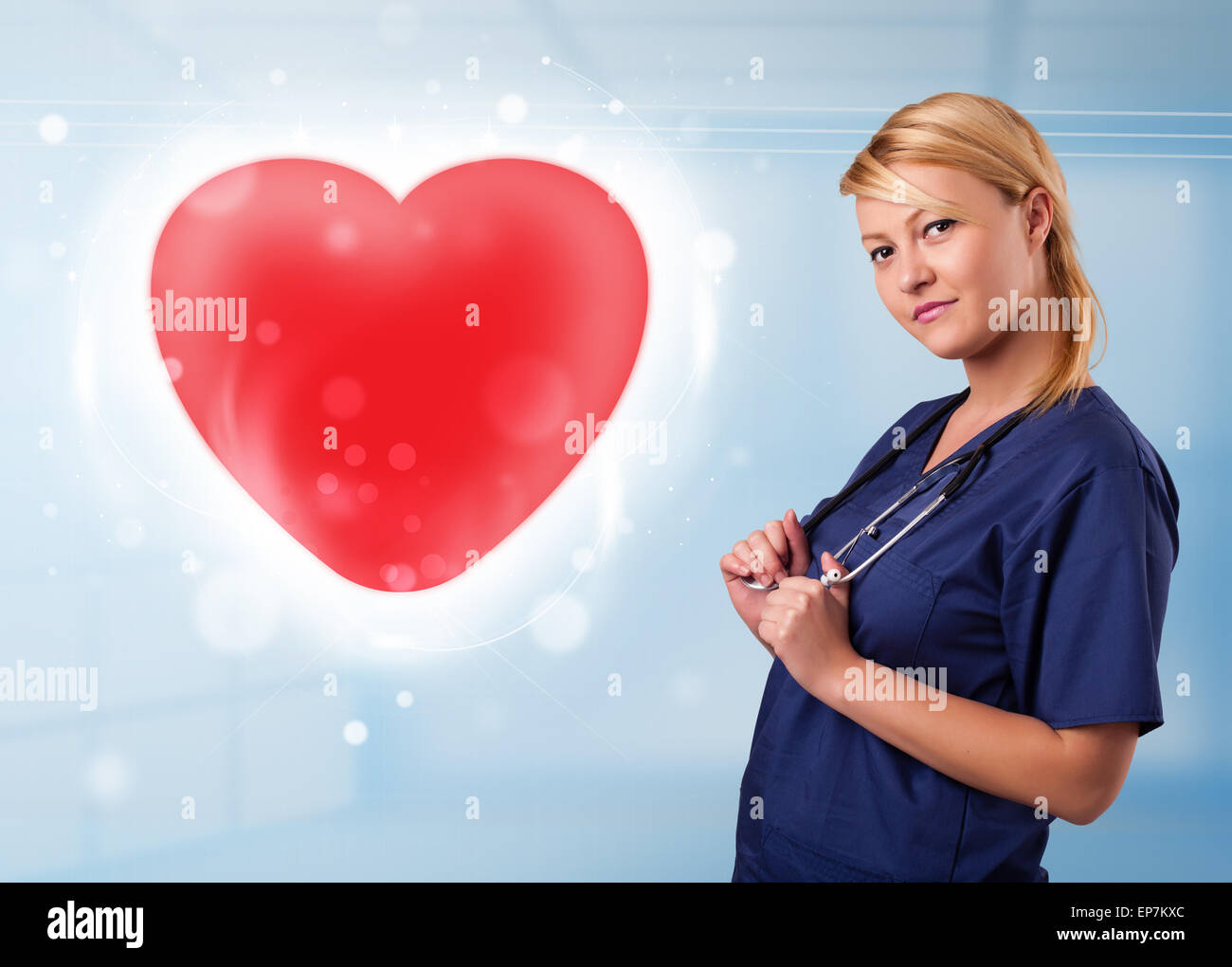 Young nurse healing a red heart Stock Photo - Alamy