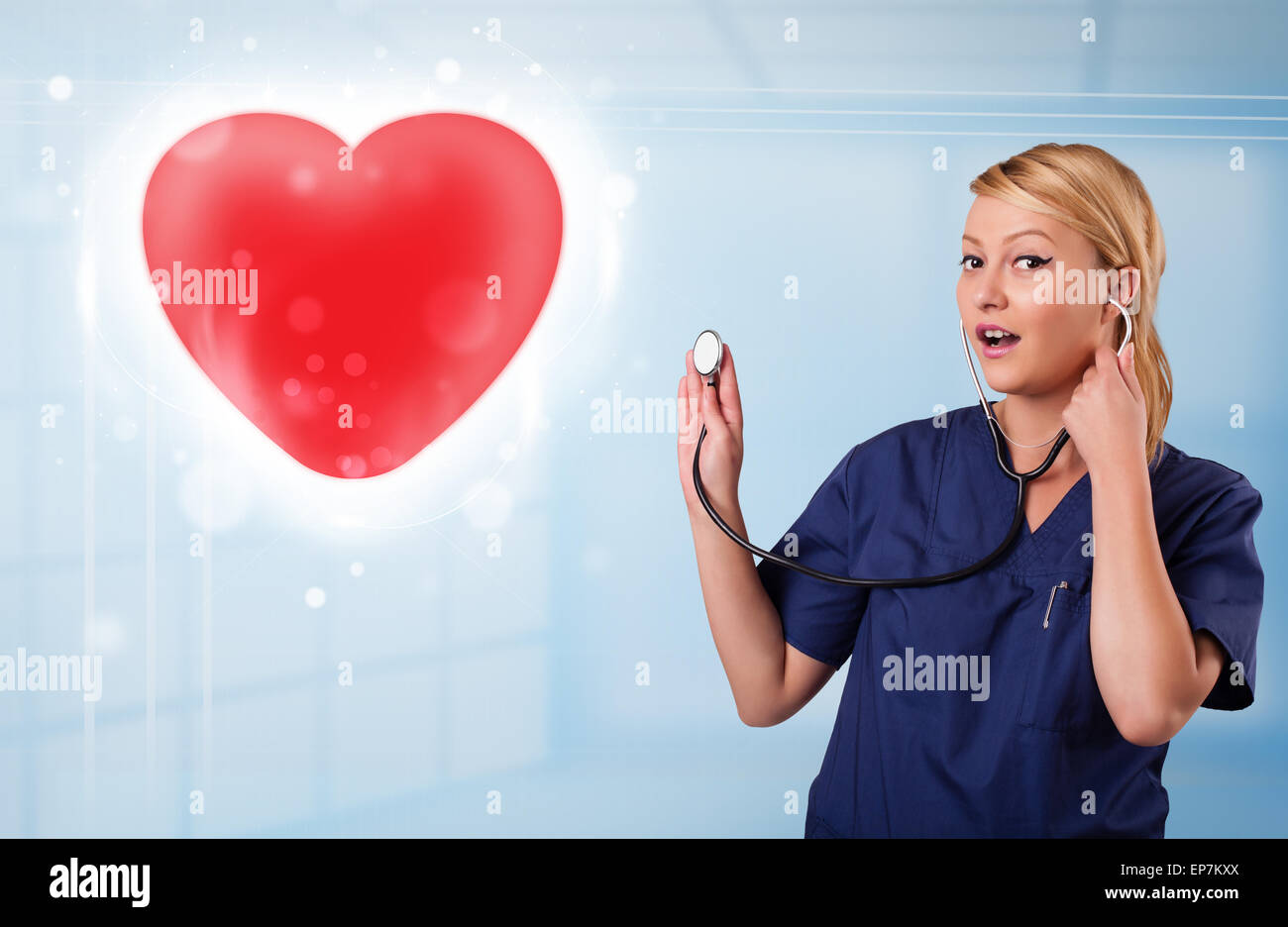 Young nurse healing a red heart Stock Photo - Alamy