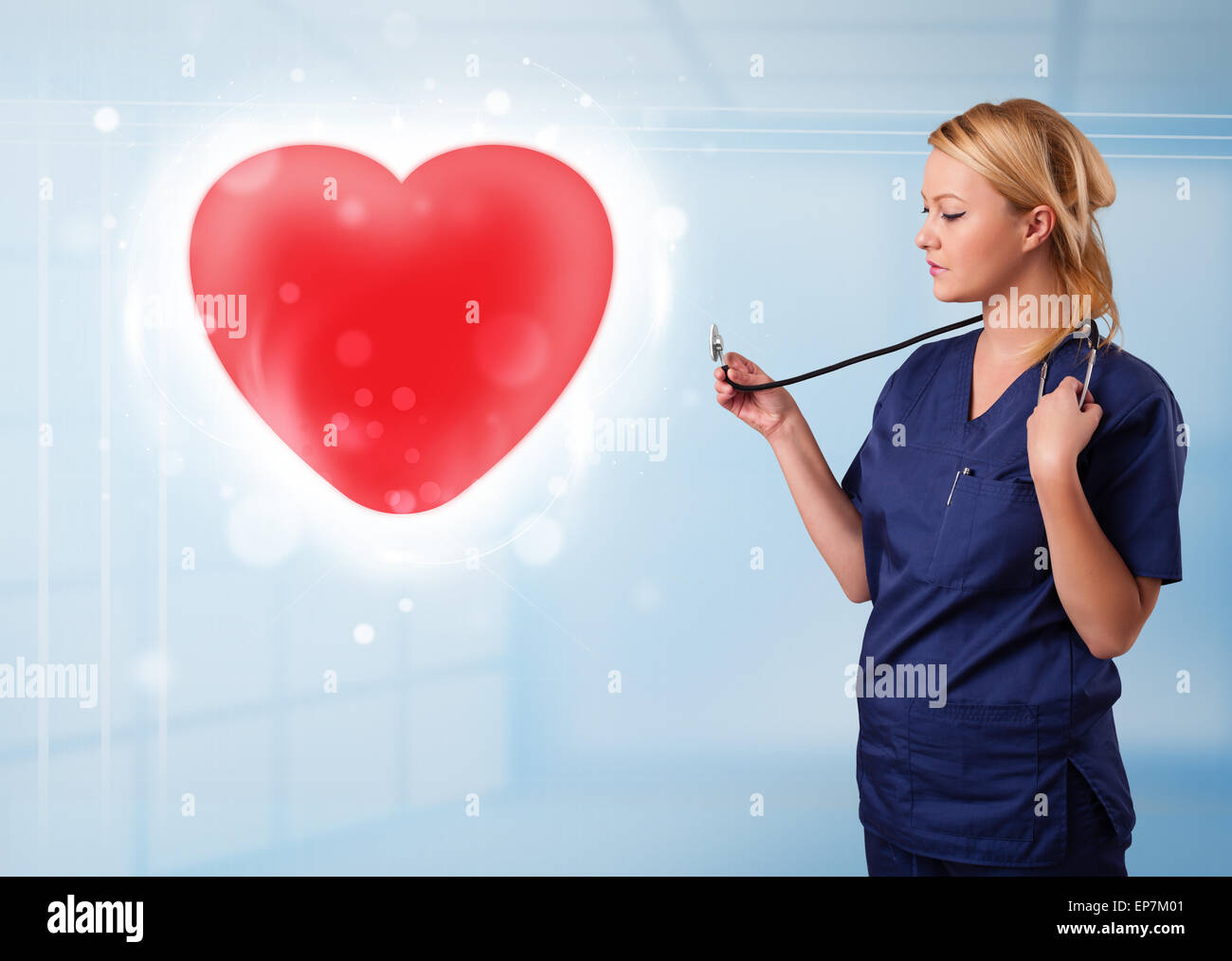 Young nurse healing a red heart Stock Photo - Alamy