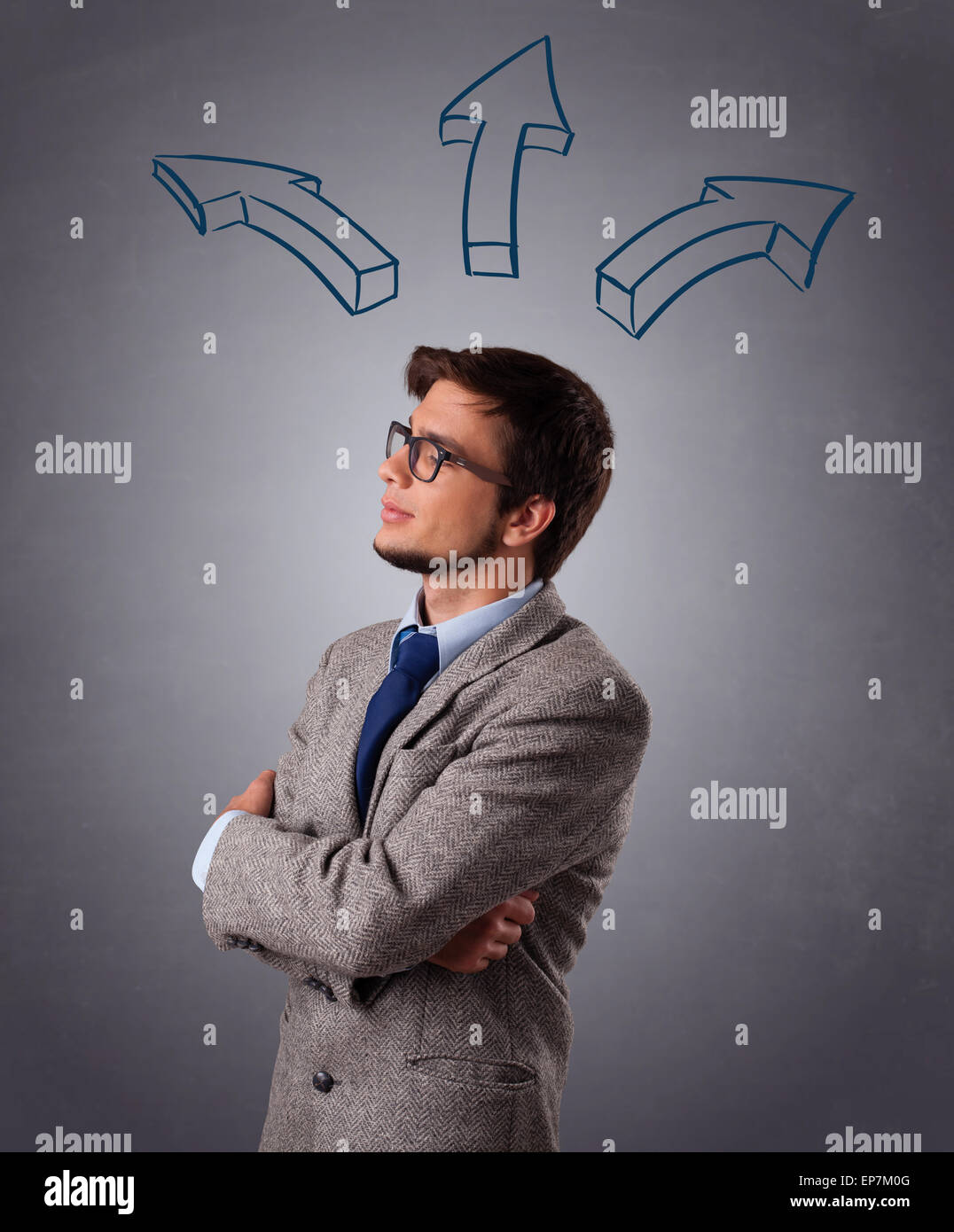 Handsome man thinking with arrows overhead Stock Photo - Alamy
