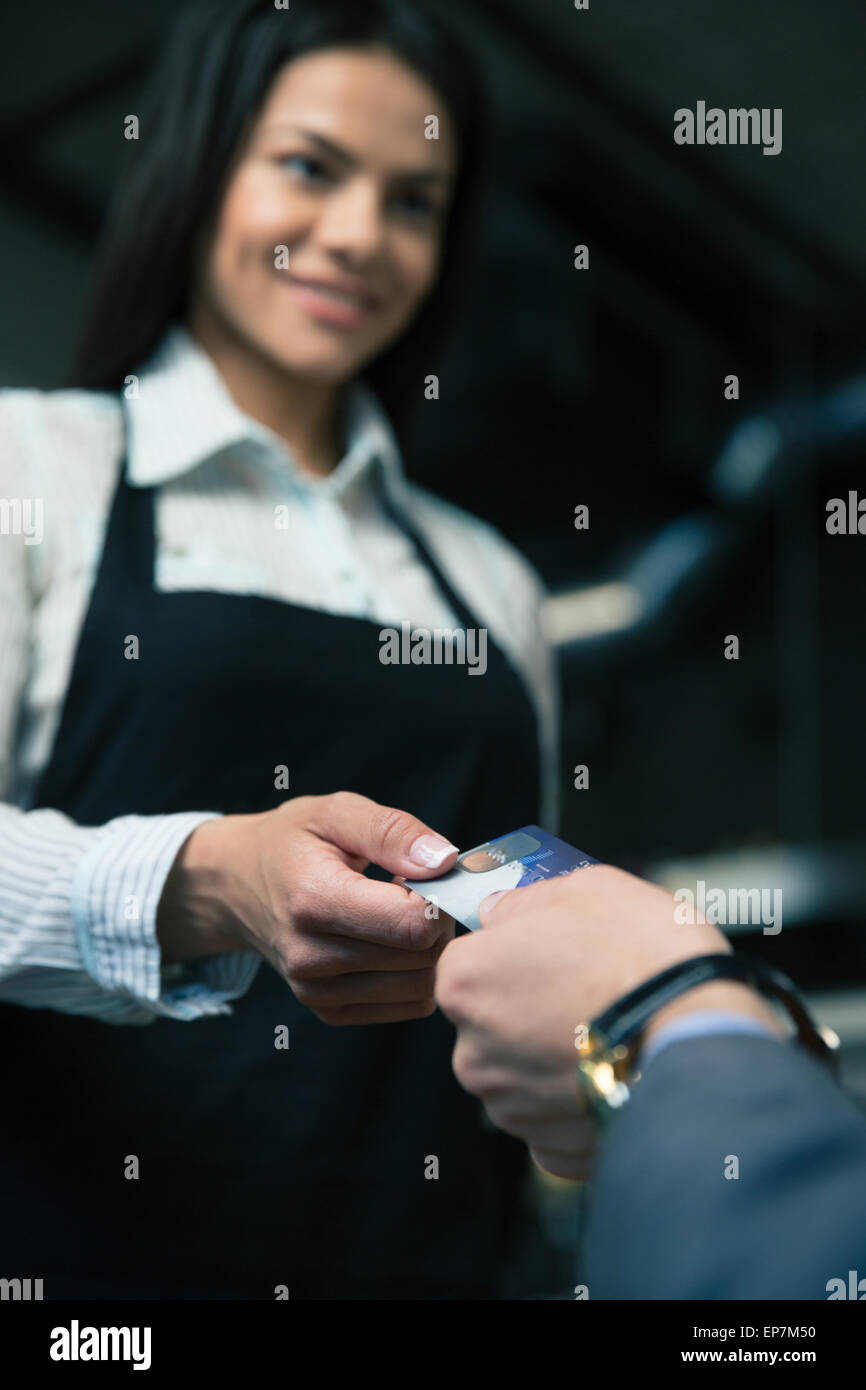Man giving bank card to female waiter in cafe. Focus on card Stock ...