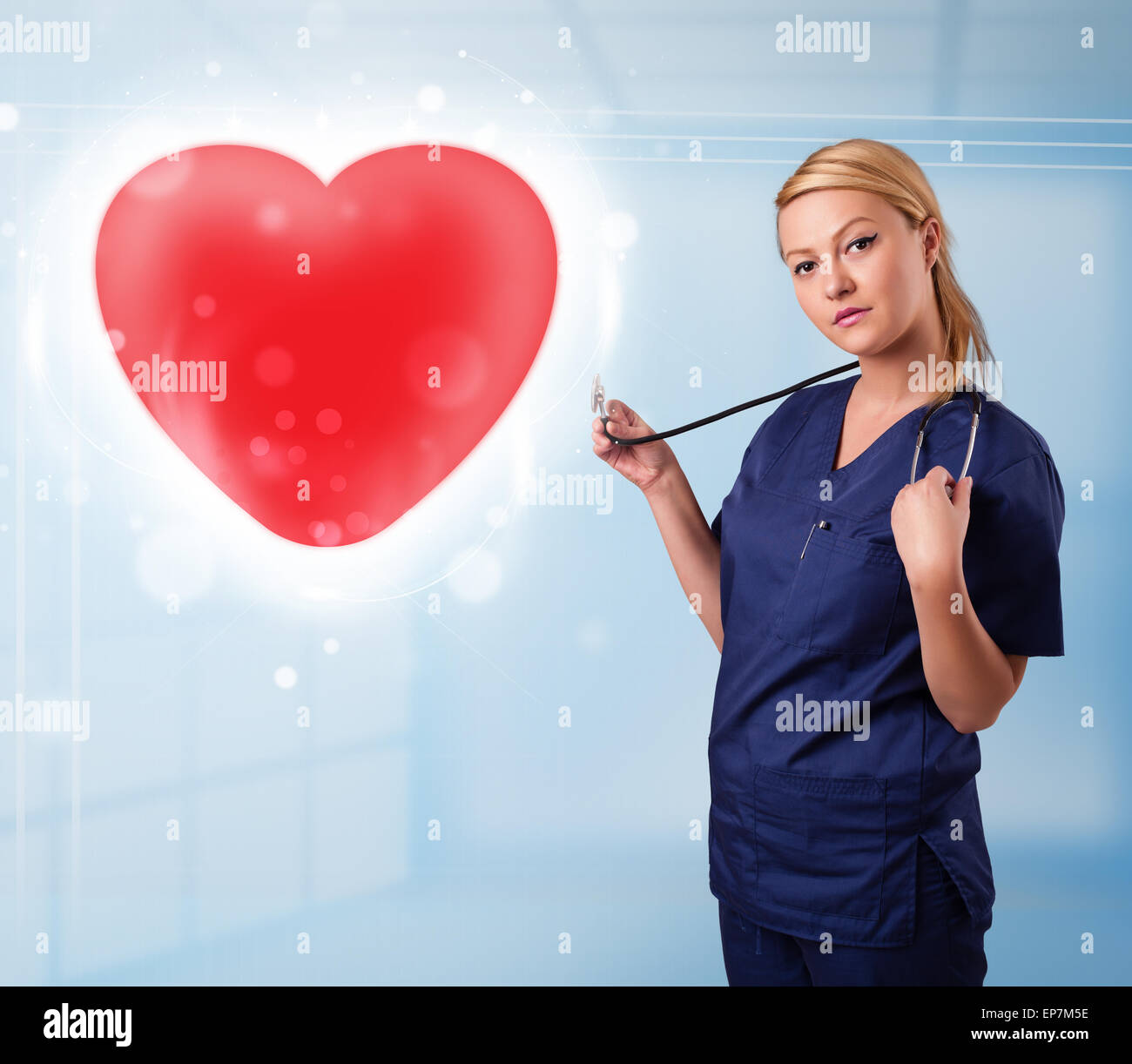 Young nurse healing a red heart Stock Photo - Alamy