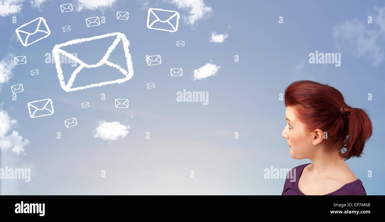 Young girl looking at mail symbol clouds on blue sky Stock Photo - Alamy
