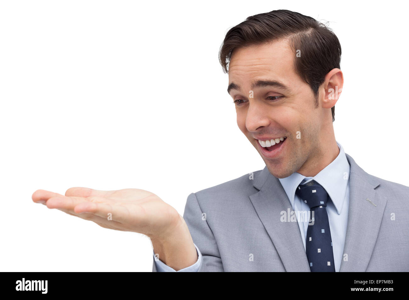 Smiling businessman looking at and showing his opened hand Stock Photo ...