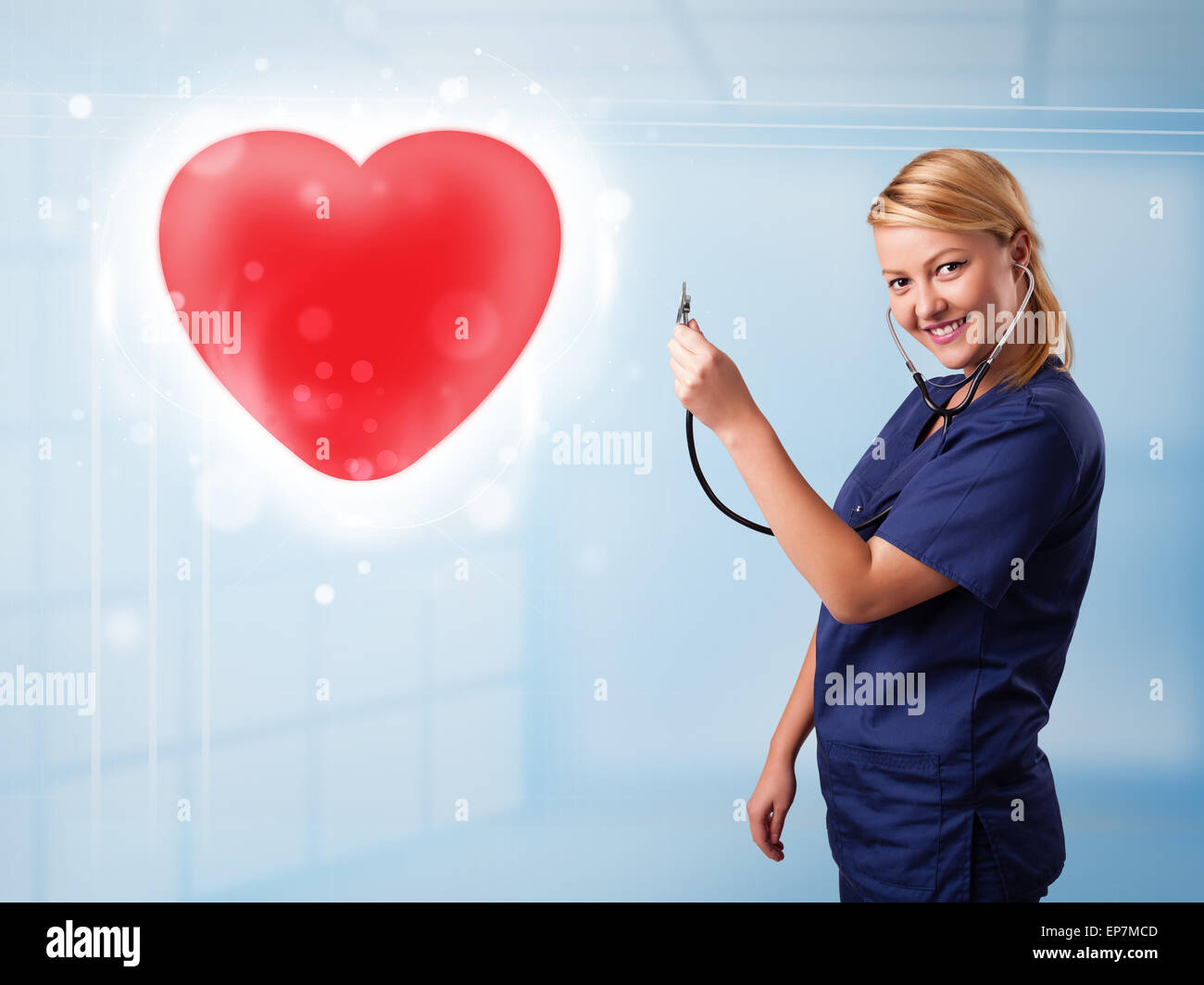 Young nurse healing a red heart Stock Photo - Alamy