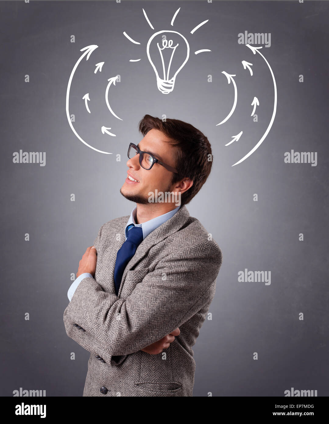 Young man thinking with arrows and light bulb overhead Stock Photo - Alamy