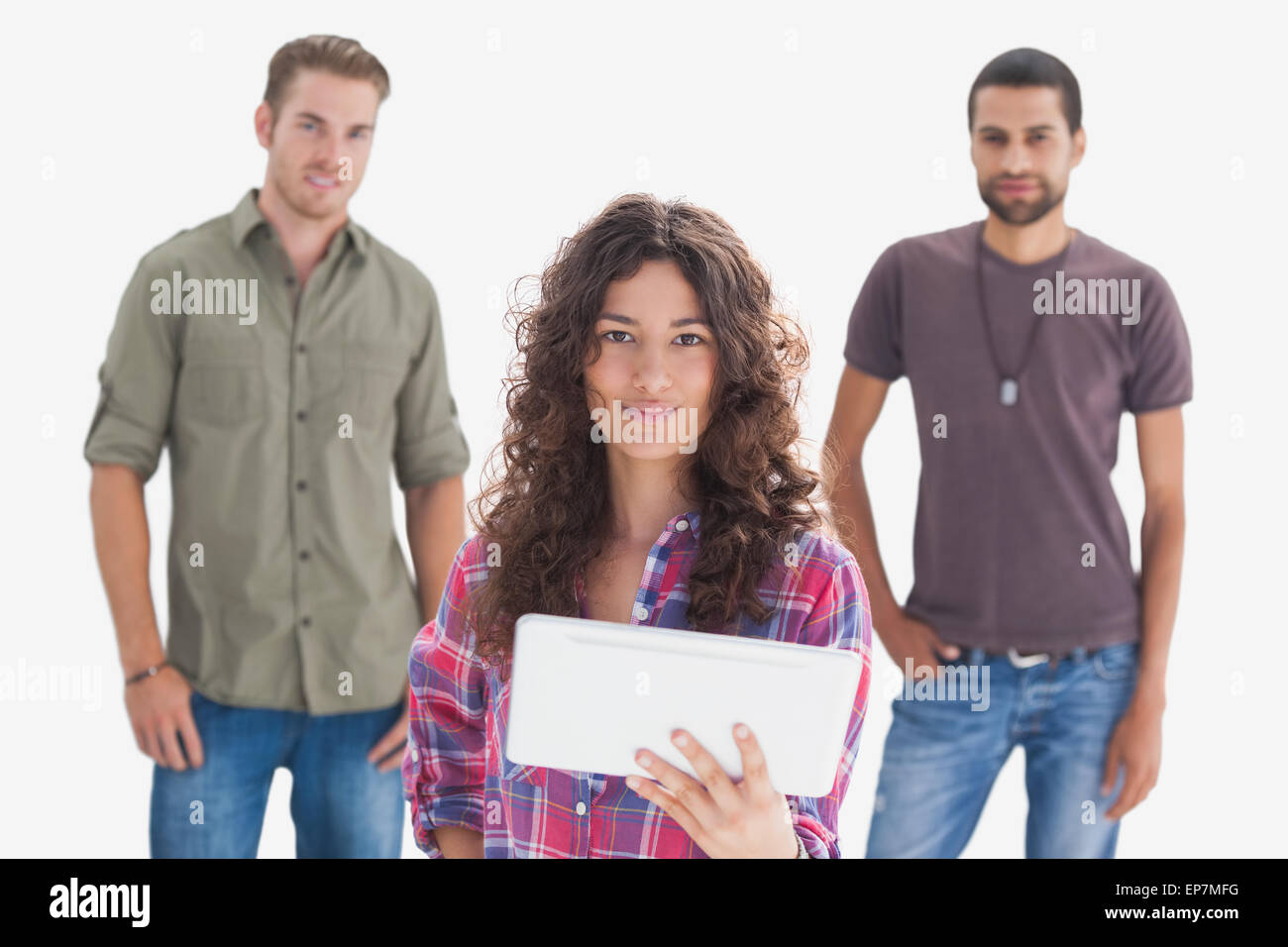 Stylish friends looking at camera with one holding tablet Stock Photo ...
