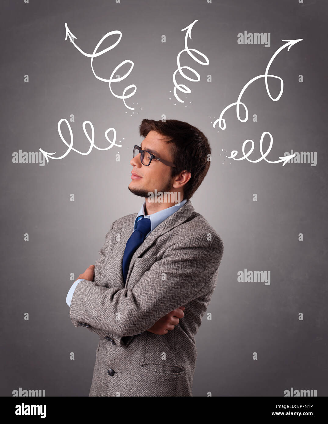 Young man thinking with arrows overhead Stock Photo - Alamy