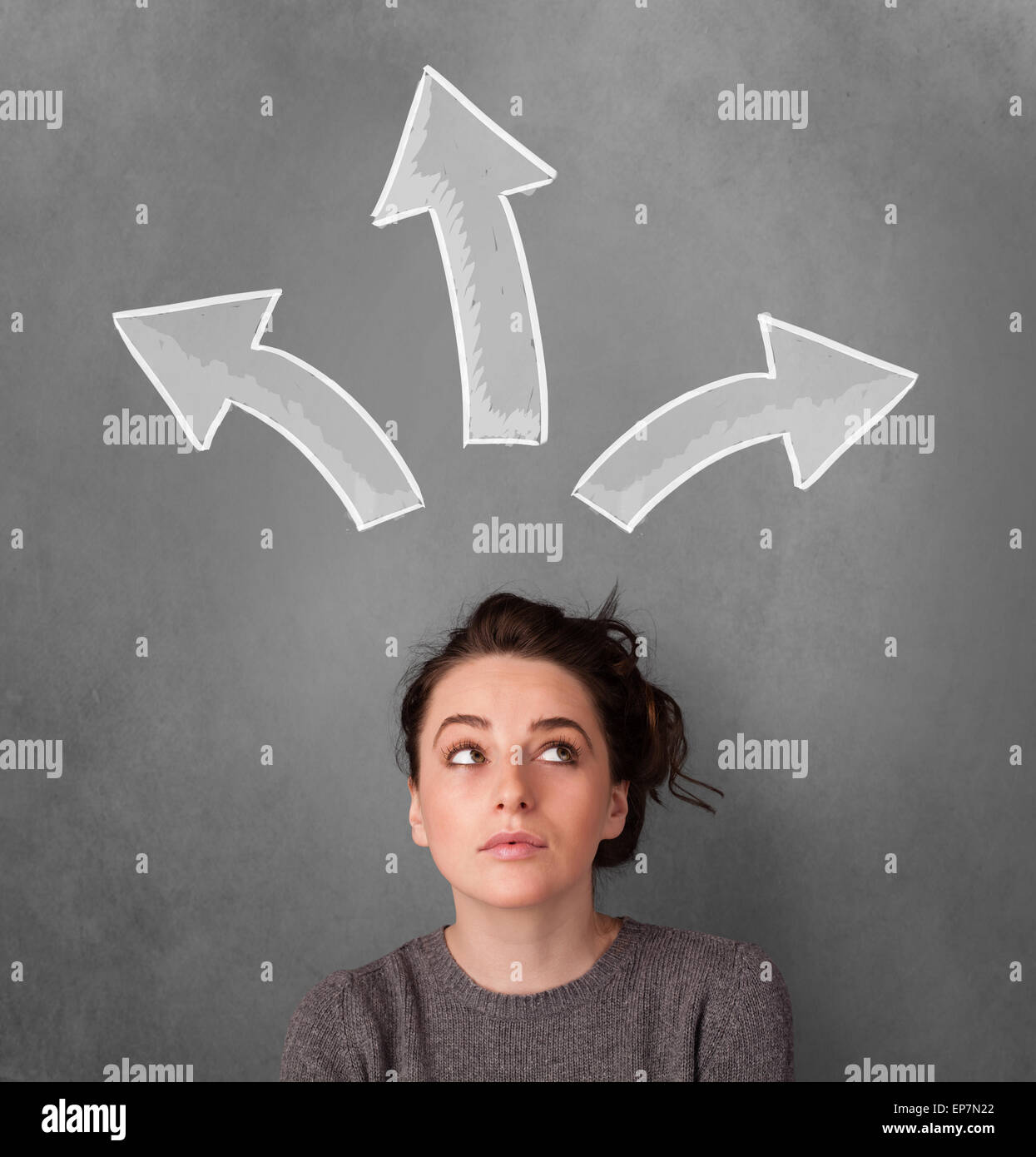 Young woman thinking with arrows above her head Stock Photo - Alamy