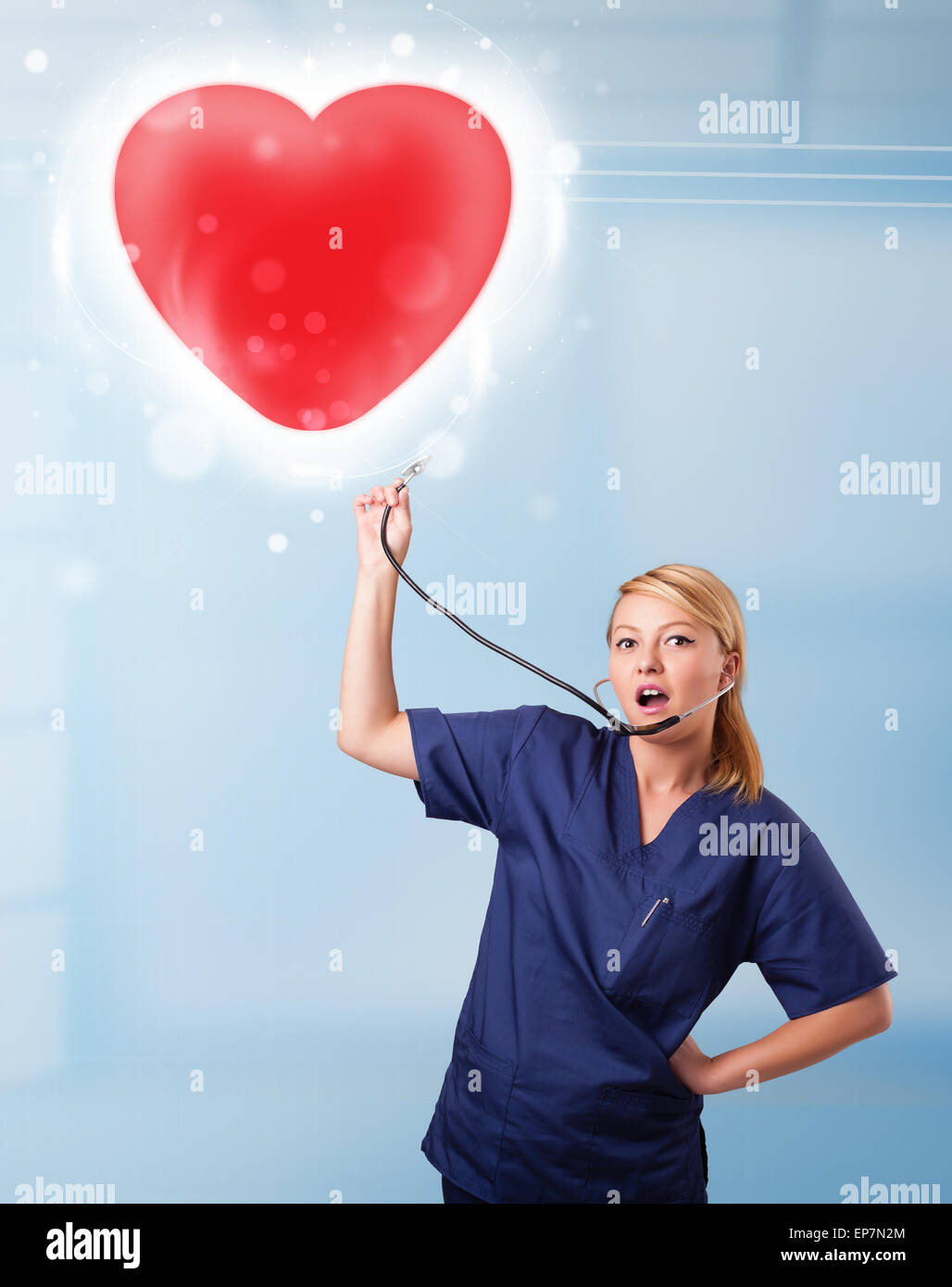 Young nurse healing a red heart Stock Photo - Alamy