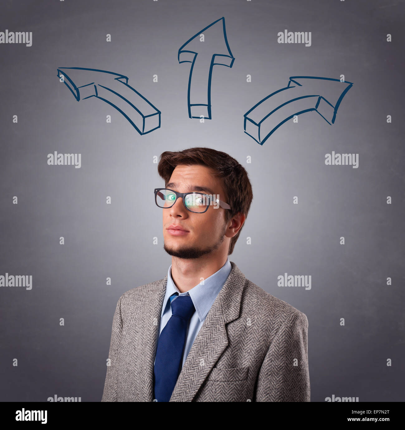 Handsome man thinking with arrows overhead Stock Photo - Alamy