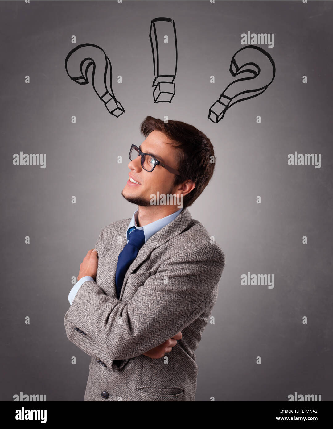 Young man thinking with question marks overhead Stock Photo - Alamy