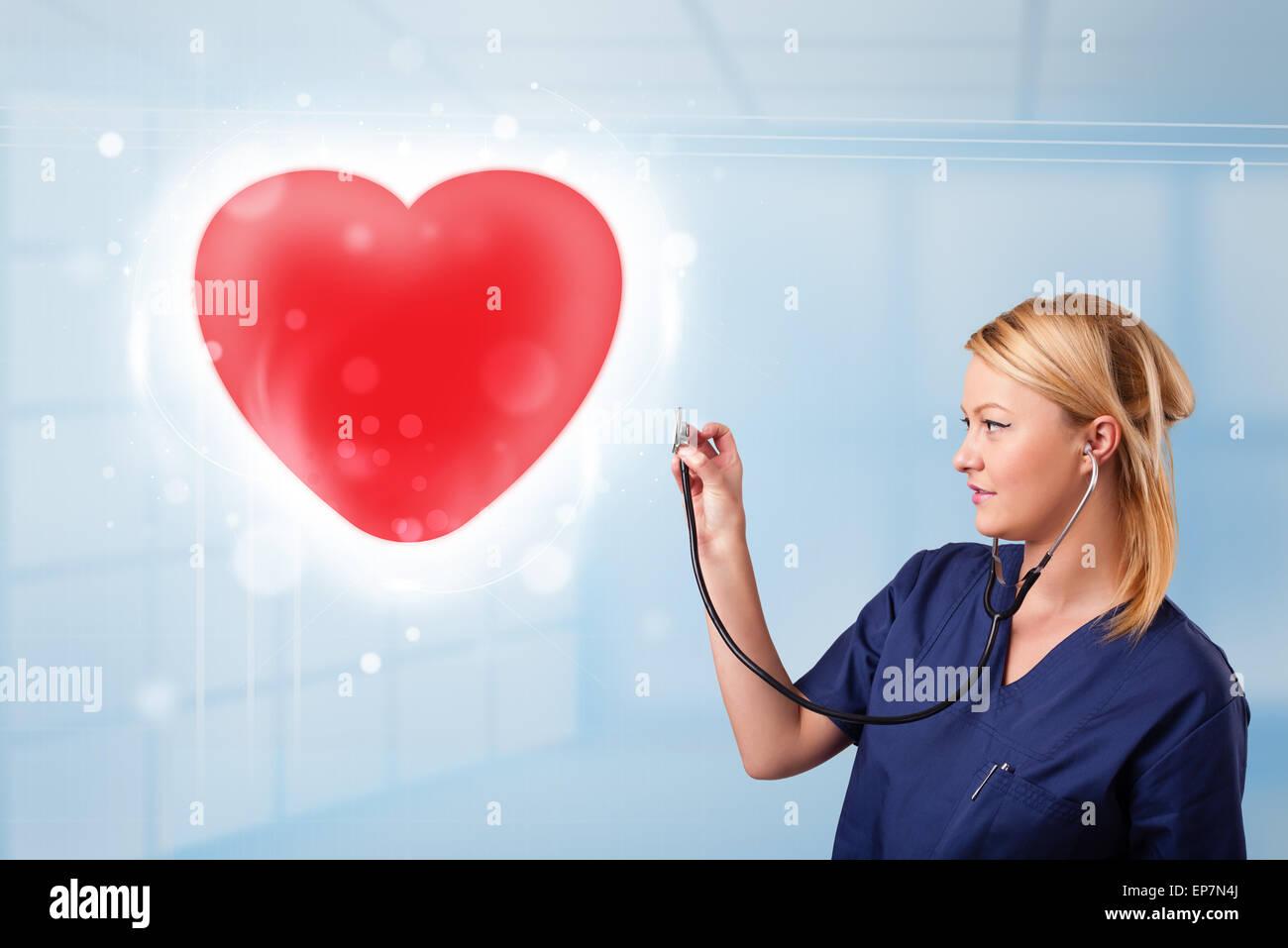 Young nurse healing a red heart Stock Photo - Alamy