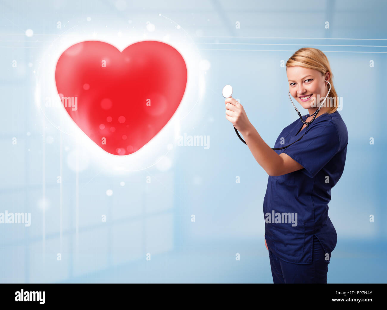 Young nurse healing a red heart Stock Photo - Alamy