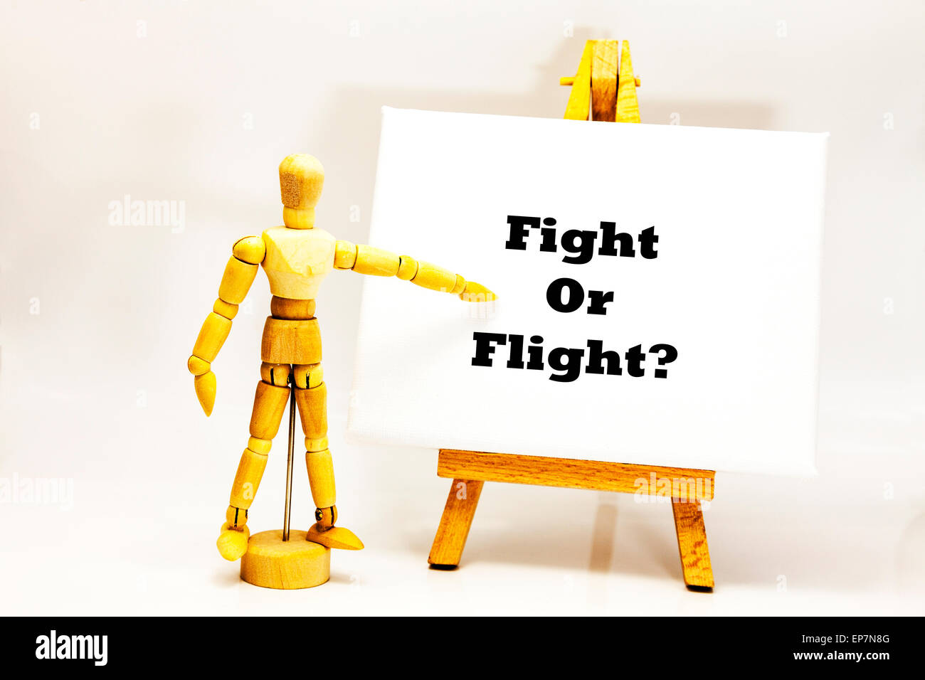 Wooden man with white board pointing at words "Fight or Flight ...