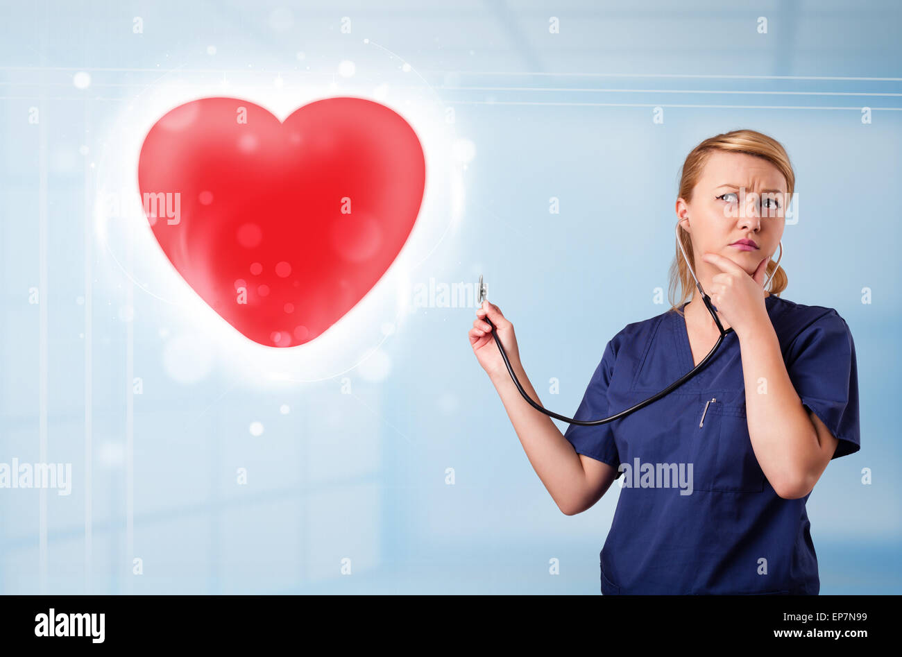 Young nurse healing a red heart Stock Photo - Alamy