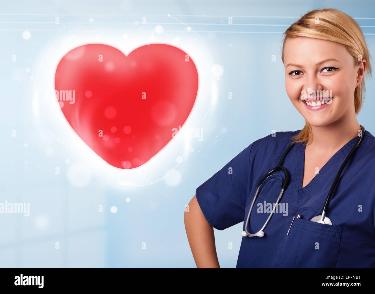 Young nurse healing a red heart Stock Photo - Alamy