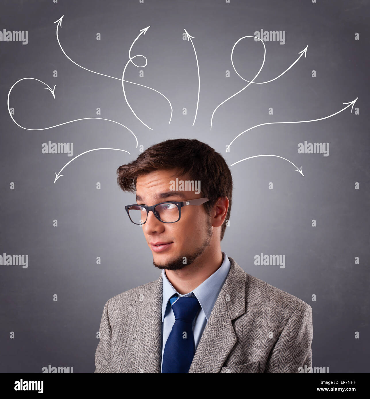 Young man thinking with arrows overhead Stock Photo - Alamy