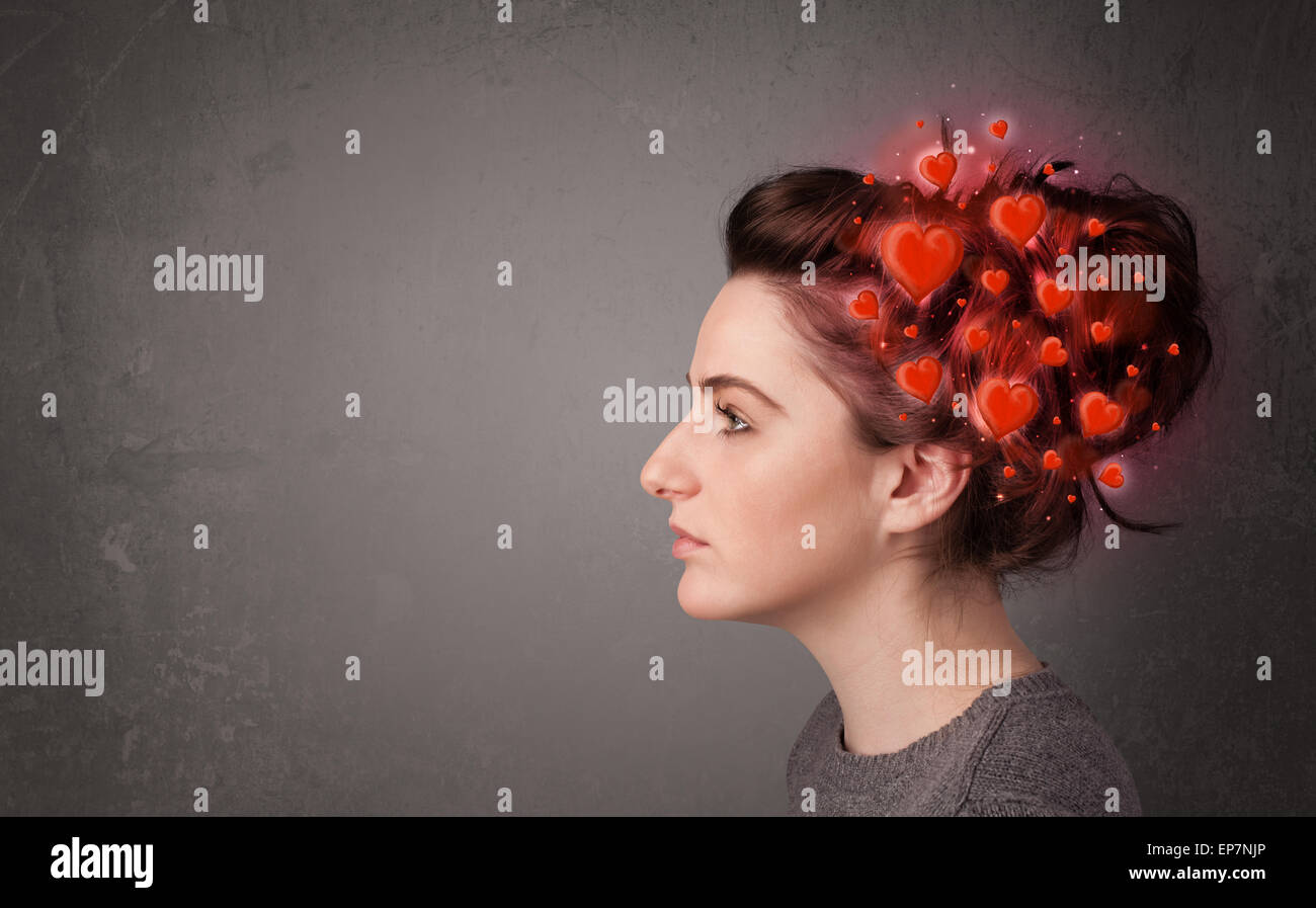 Young person thinking about love with red hearts Stock Photo - Alamy