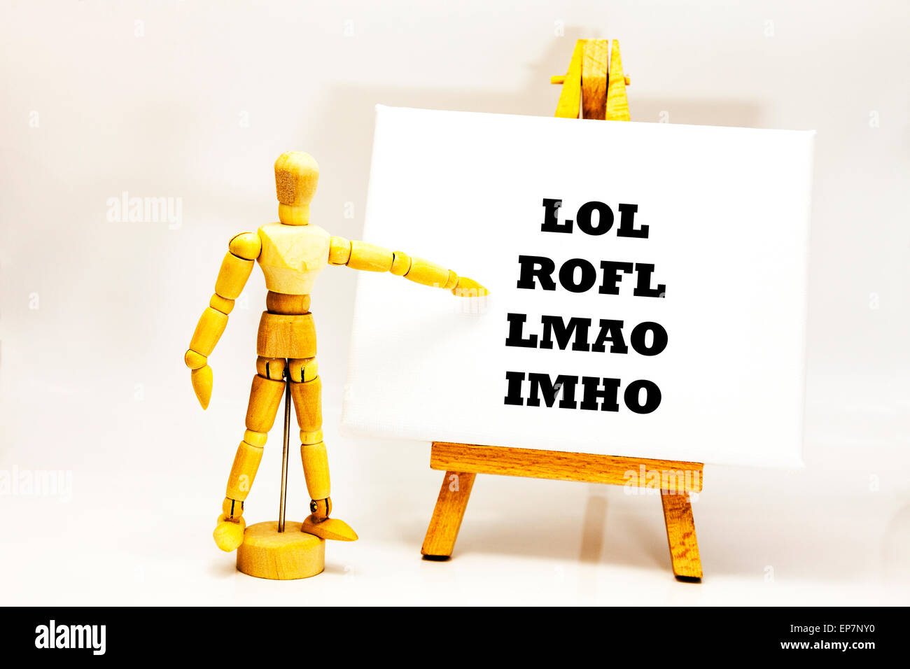 Wooden man with white board pointing at words "lol rofl lmao imho" text ...